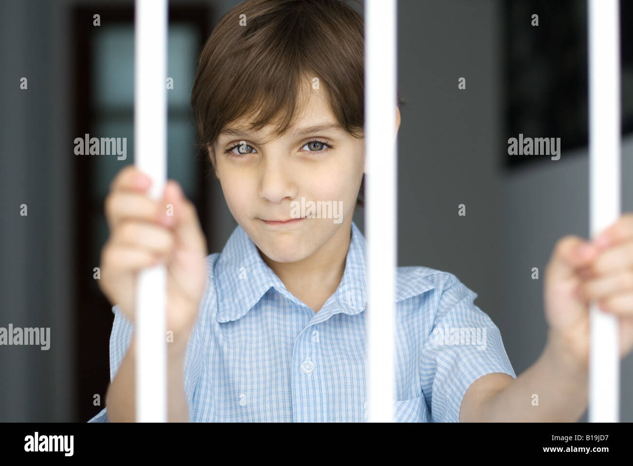 Boy behind bars hi-res stock photography and images - Alamy