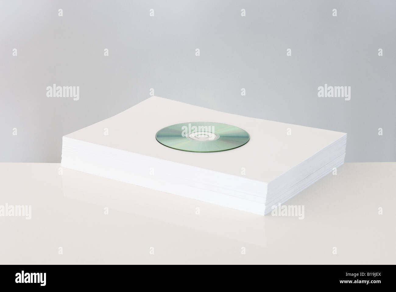 CD on top of stacked paper Stock Photo - Alamy