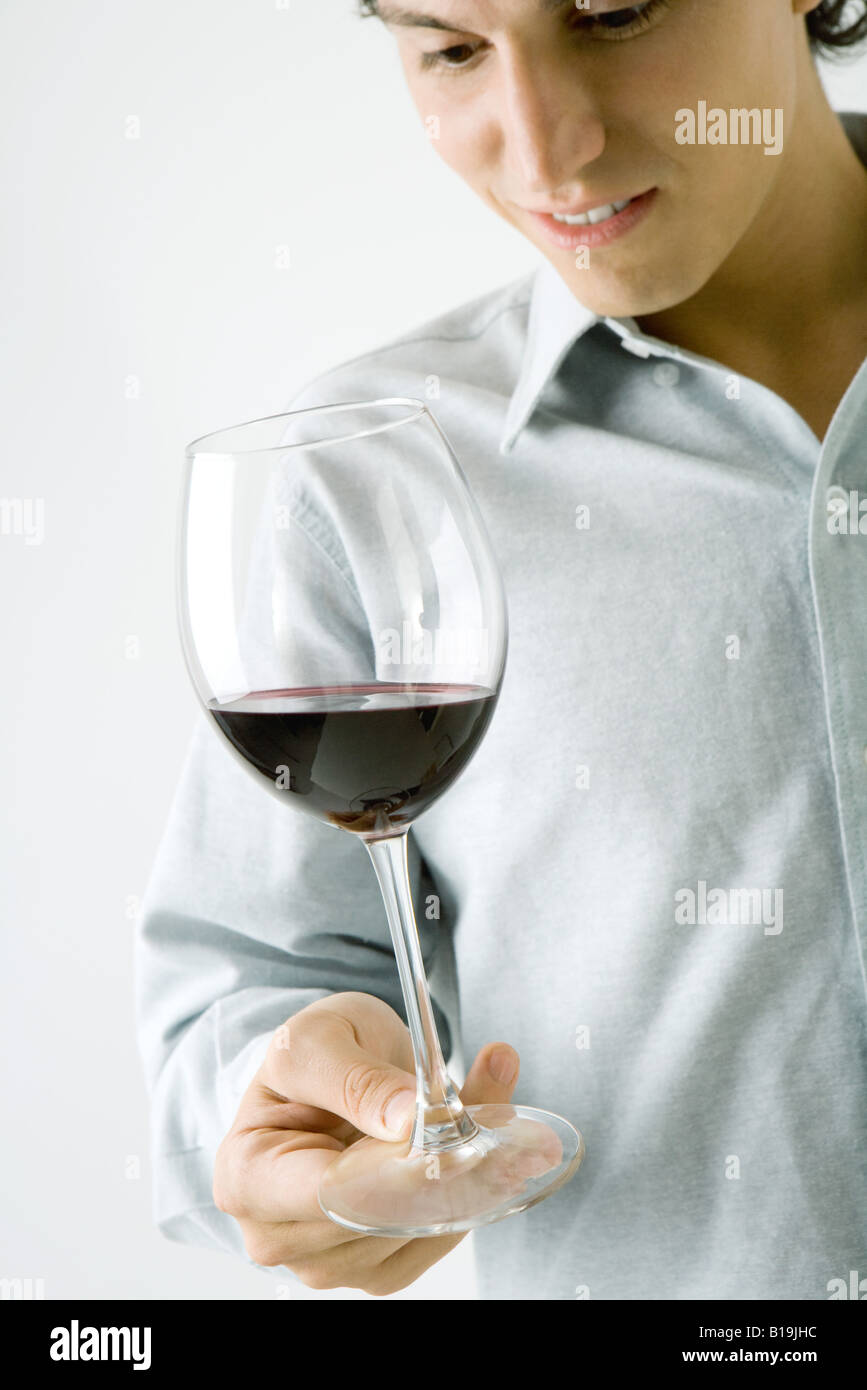 Man holding glass of red wine, cropped view Stock Photo - Alamy