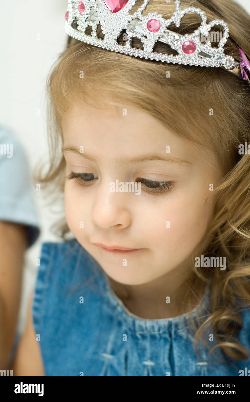 Little girl wearing toy tiara, looking down, close-up Stock Photo - Alamy