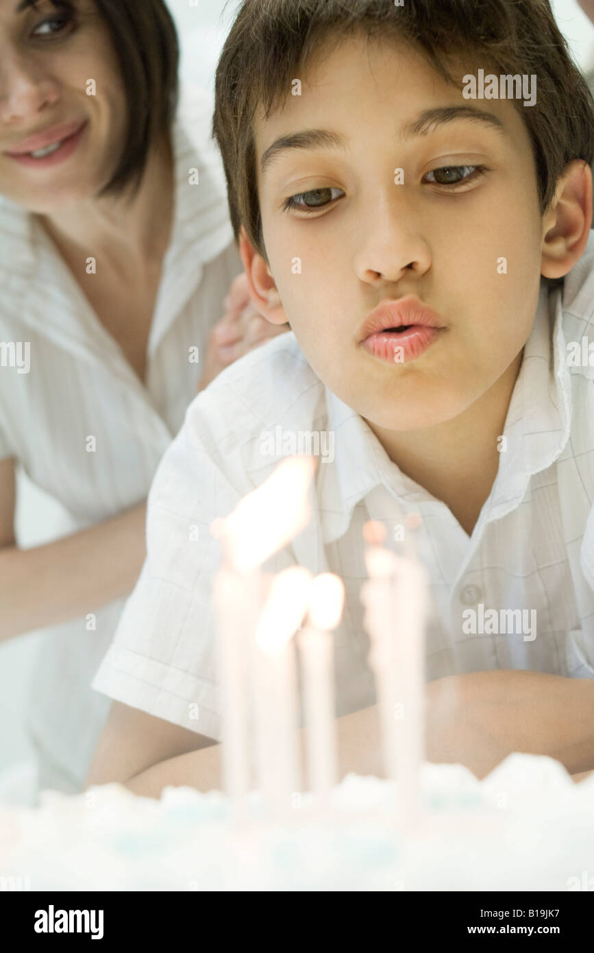 Boy blowing out candles on birthday cake, close-up Stock Photo - Alamy