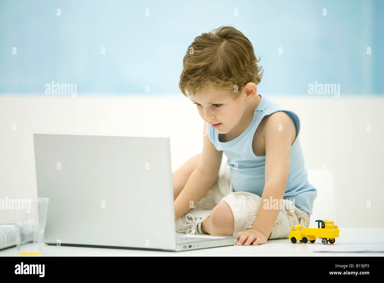 Little boy looking at laptop computer Stock Photo - Alamy