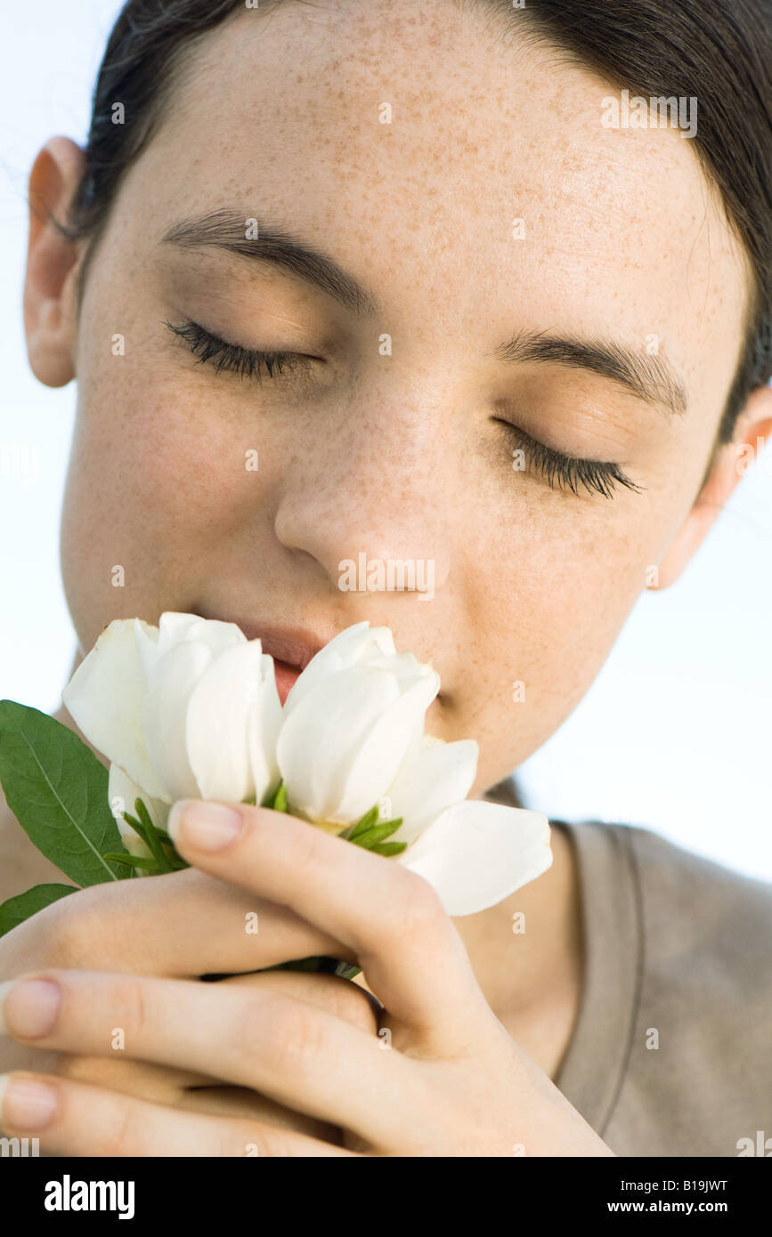 Young woman smelling flowers, close-up Stock Photo - Alamy