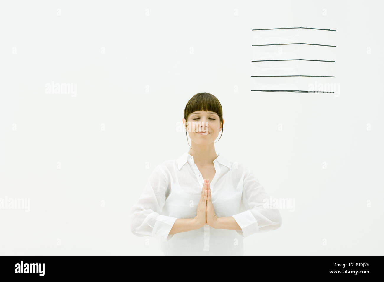 Woman in prayer position, smiling, eyes closed Stock Photo - Alamy