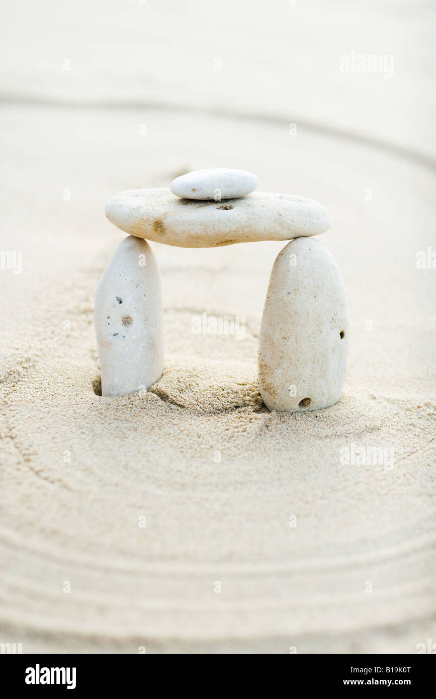 Pebbles stacked in arch formation Stock Photo - Alamy