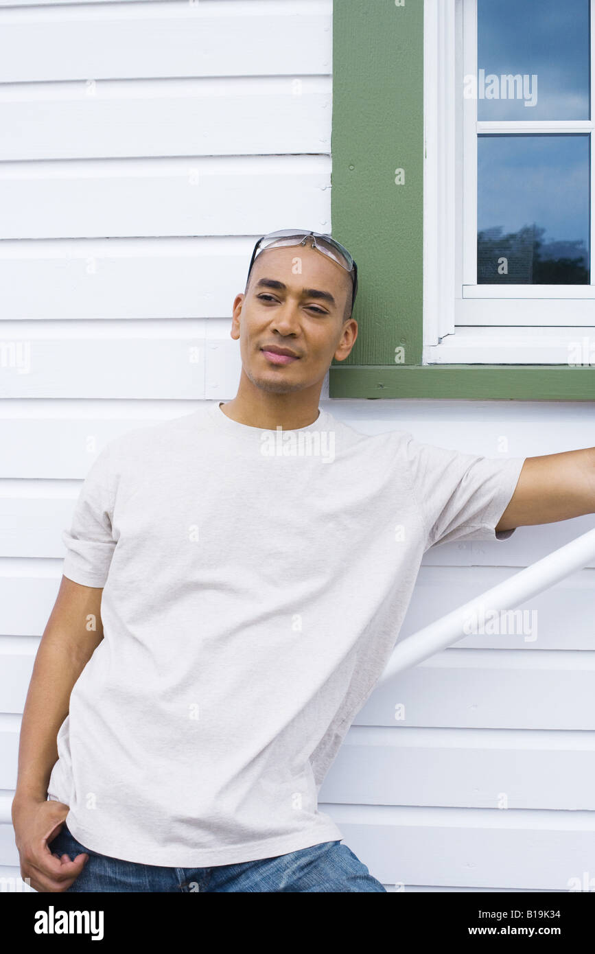 Man leaning against railing, looking away Stock Photo - Alamy