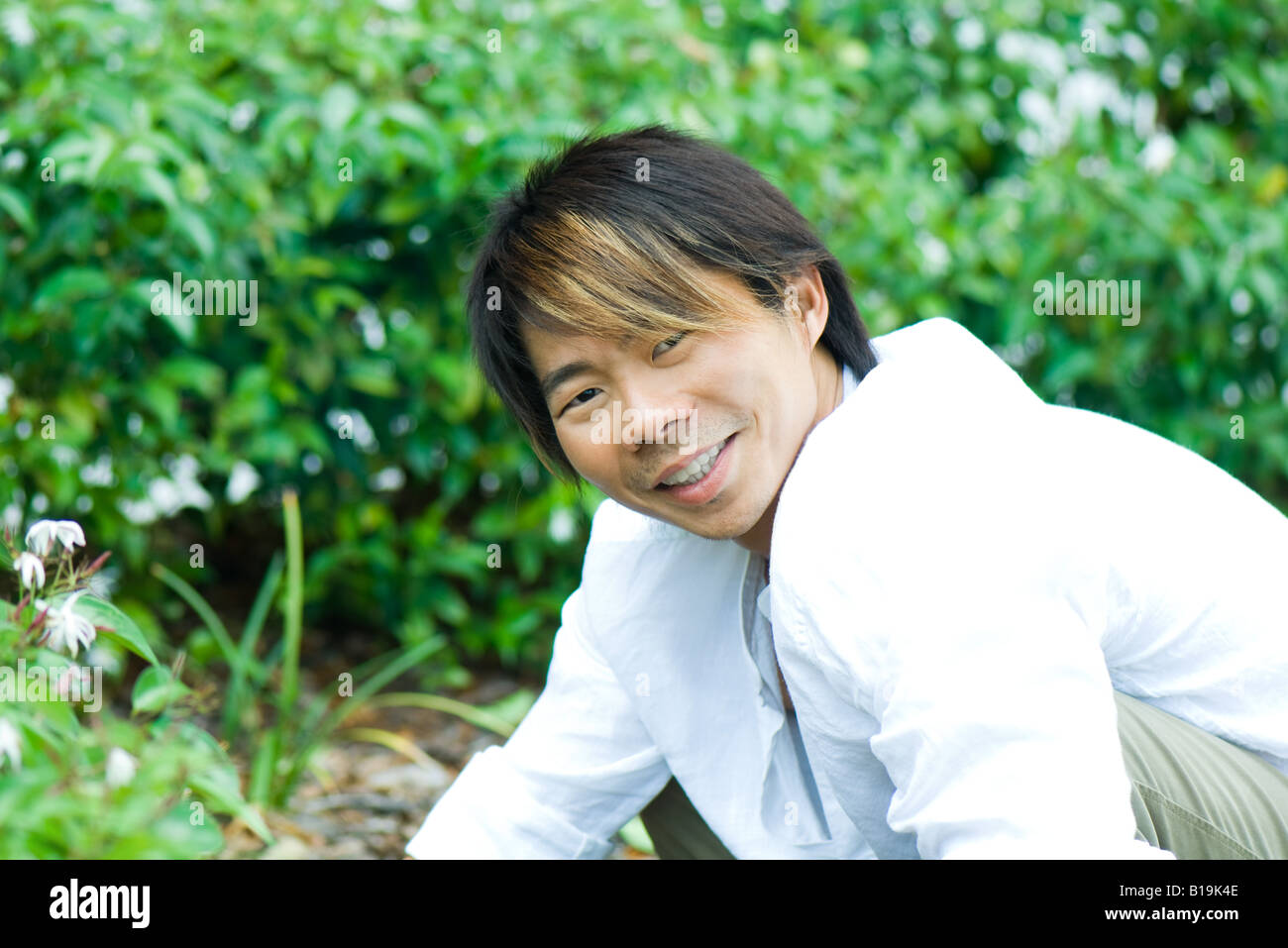 Man in garden, smiling at camera Stock Photo - Alamy