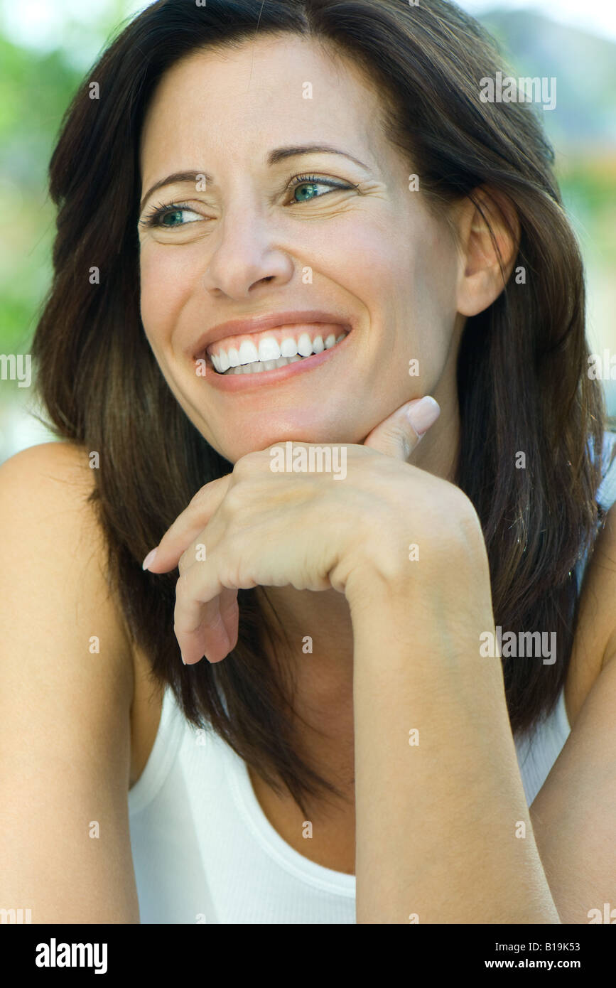 Woman smiling, hand under chin, portrait Stock Photo - Alamy