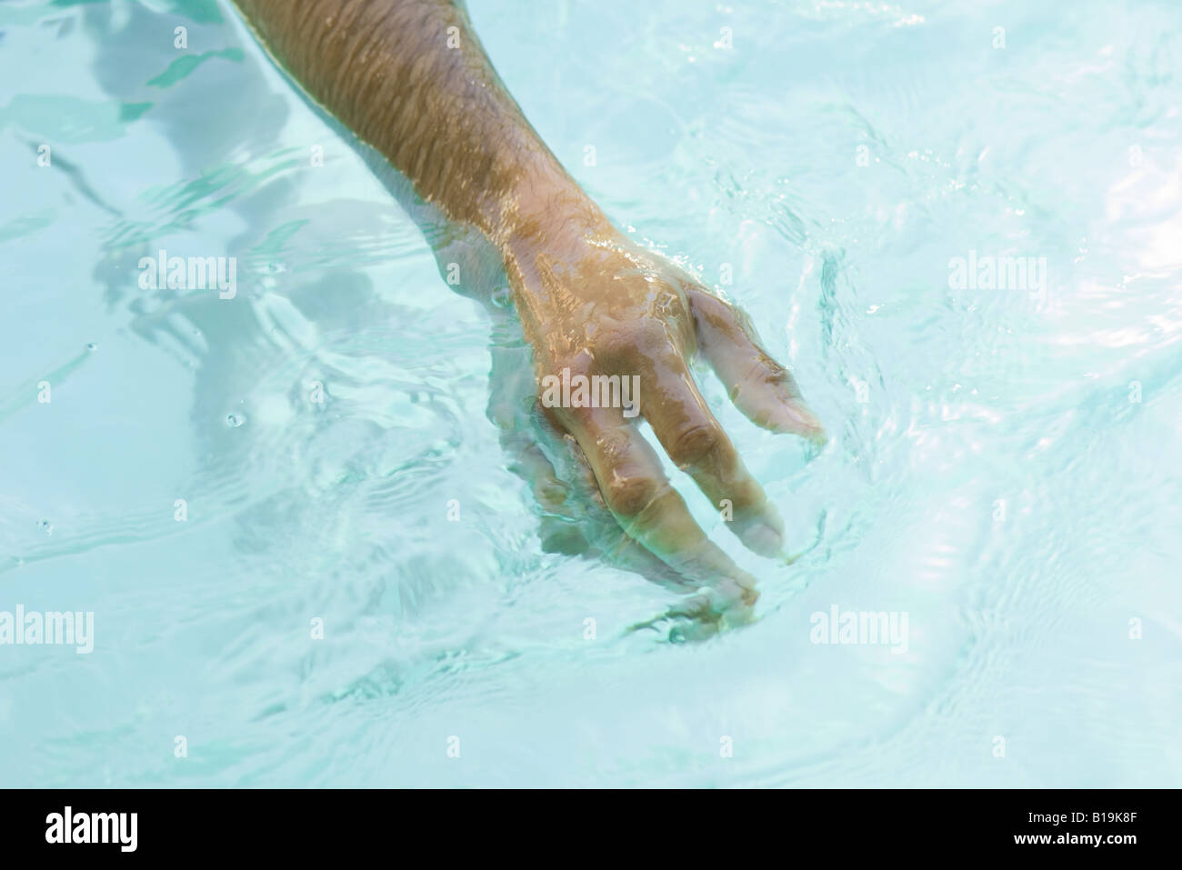Man in swimming pool, cropped view of arm Stock Photo - Alamy