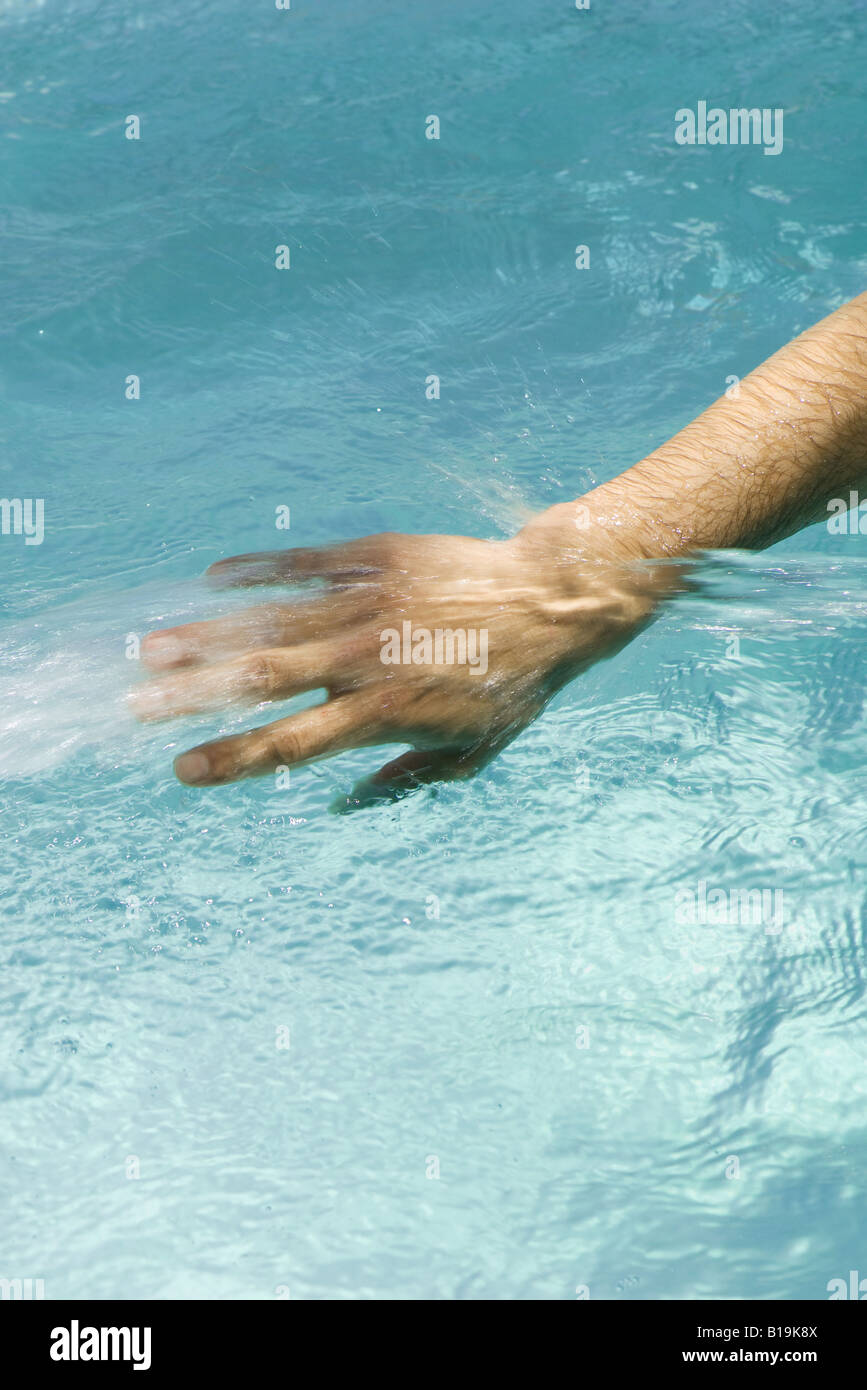 Man splashing in pool, cropped view of hand Stock Photo - Alamy
