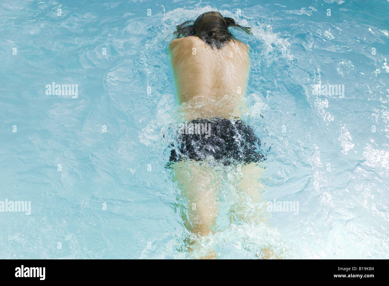 Man swimming in pool, rear view Stock Photo - Alamy