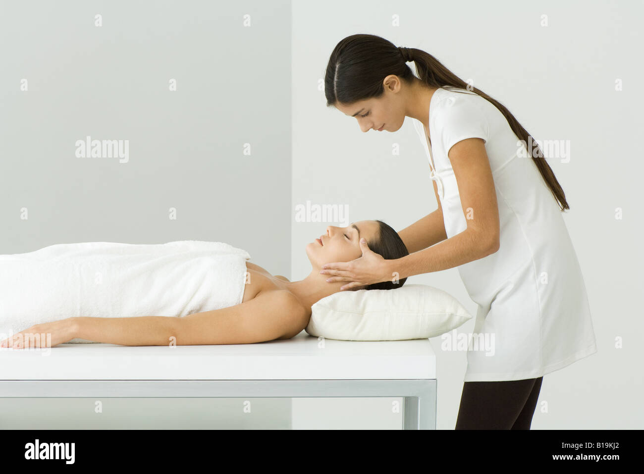 Woman receiving a head massage, side view Stock Photo - Alamy