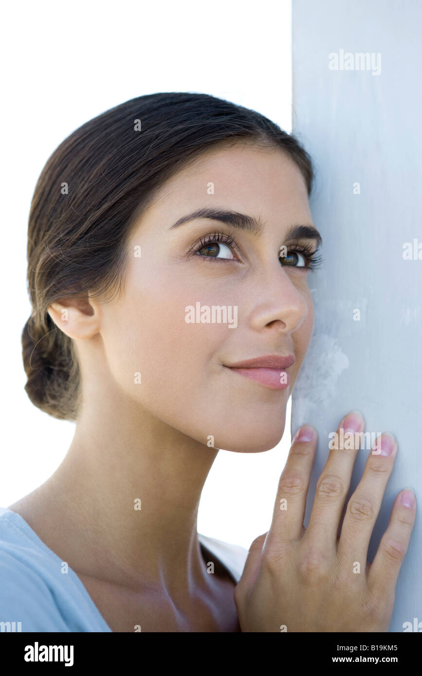 Female leaning cheek against wall hi-res stock photography and images ...