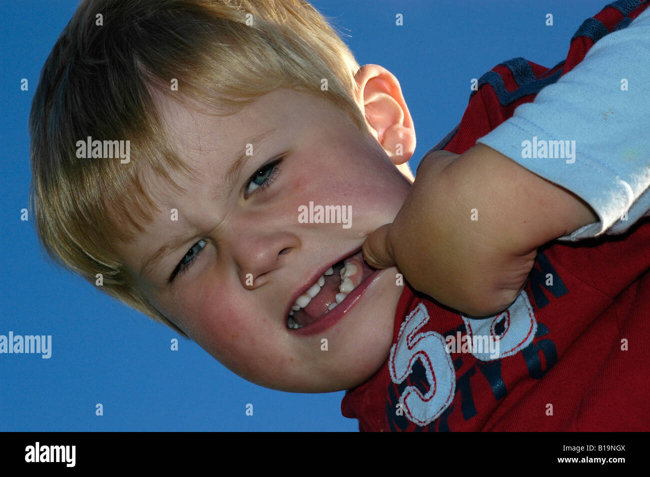 Four Year Old Boy In Menacing Mood in the uk Stock Photo - Alamy
