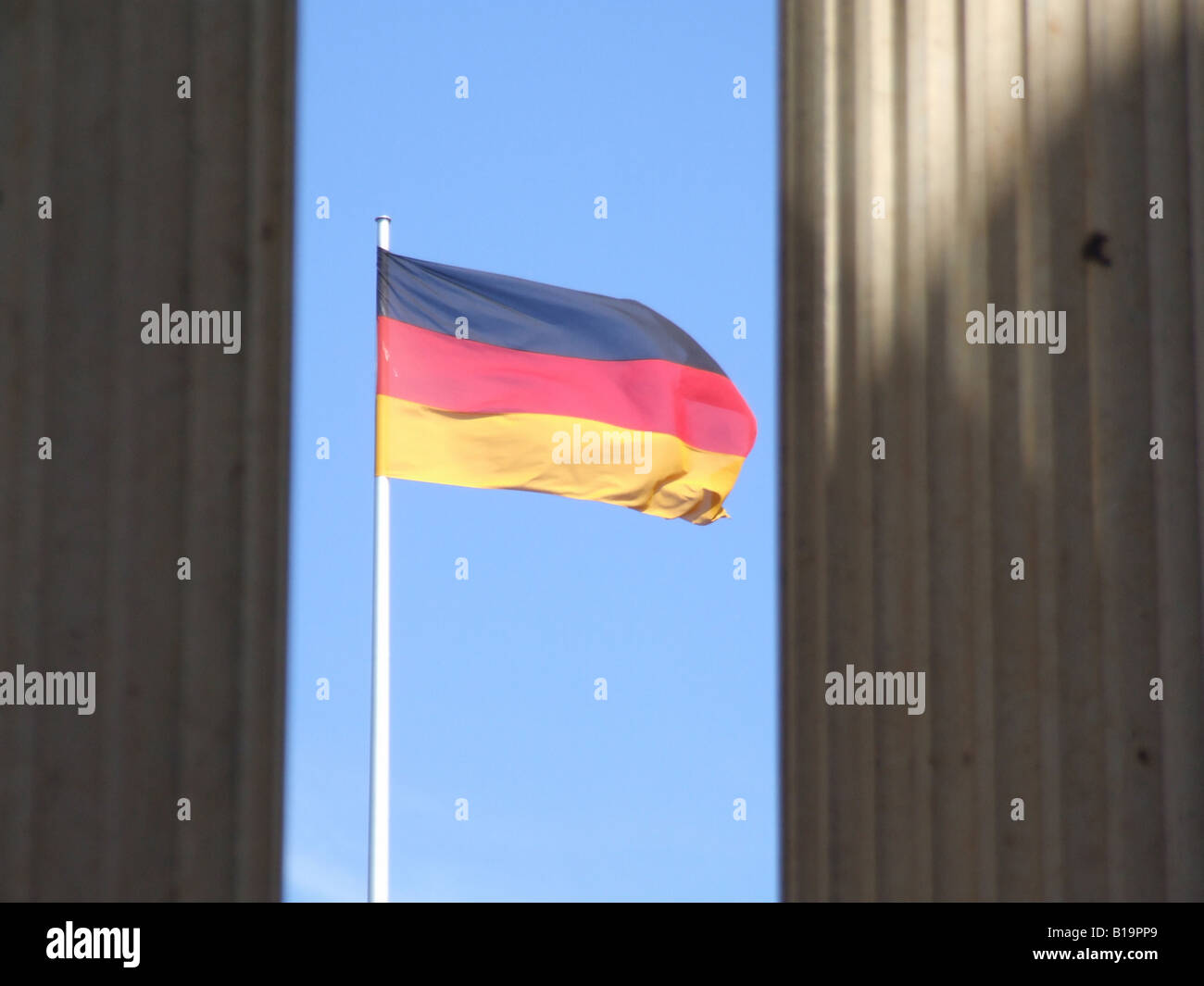 german flag flying in blue sky in berlin Stock Photo - Alamy