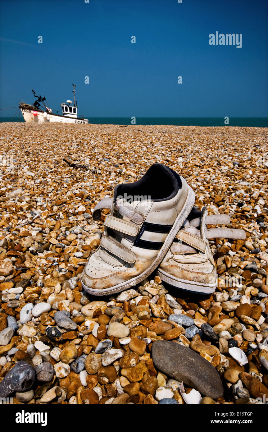 A pair of discarded trainers left on the beach at Dungeness in Kent ...