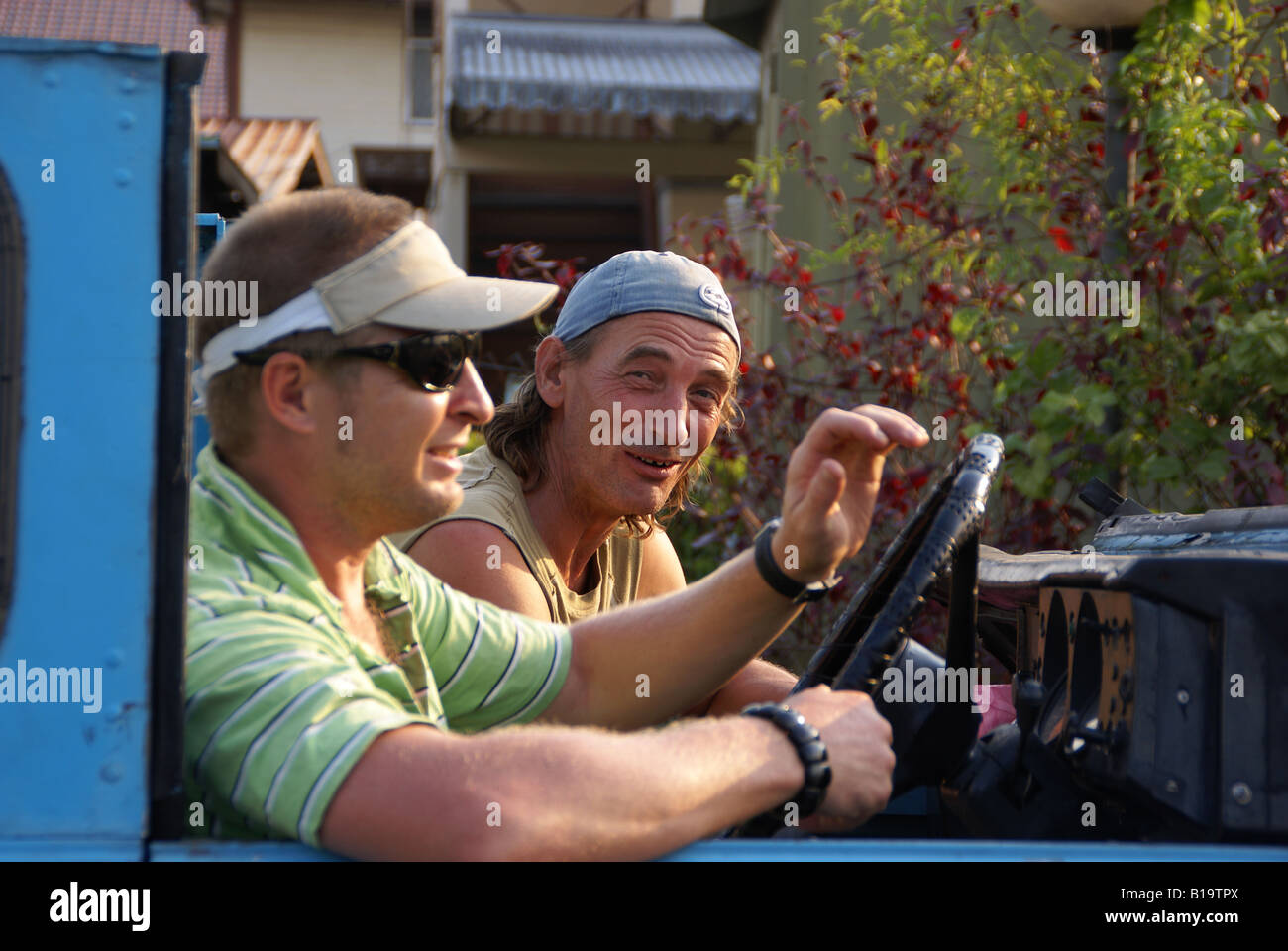 Two adventurers in a landrover Stock Photo - Alamy
