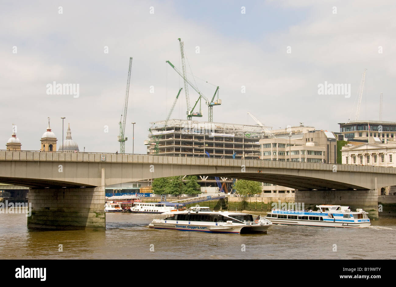 The real modern London Bridge in London with river ferry boats on the ...