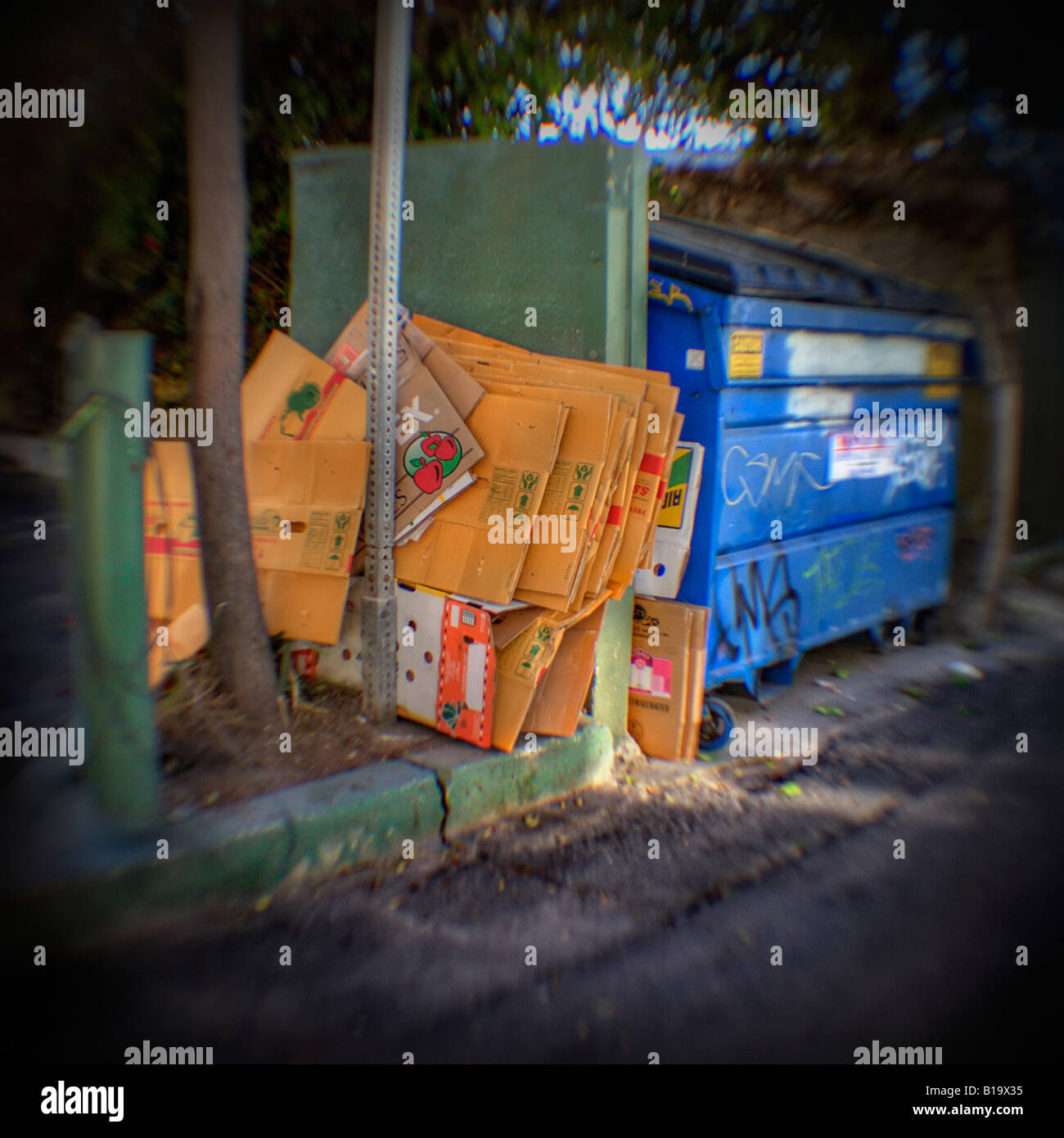 Trash Bin with discarded boxes set beside it Stock Photo - Alamy