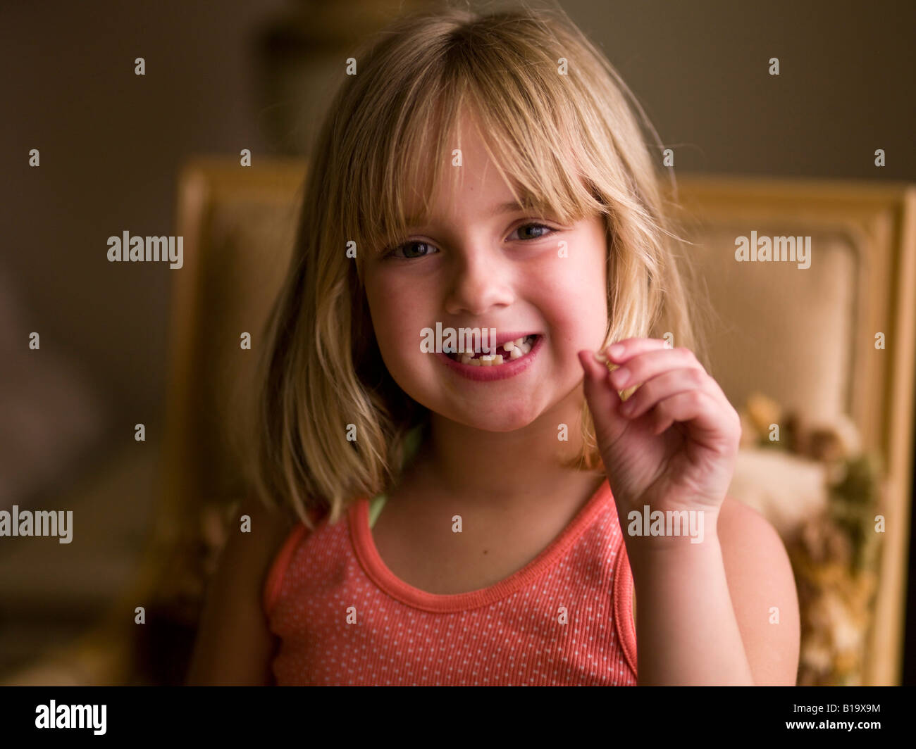 Little girl holding a tooth Stock Photo - Alamy
