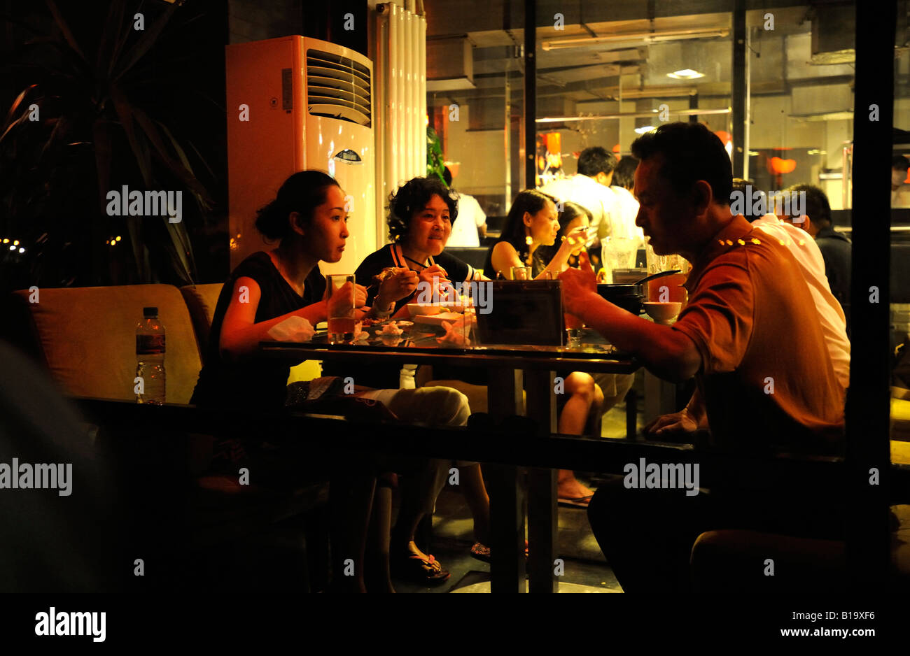 Tourists dine at a restaurant near Lake Houhai in Night Beijing China ...