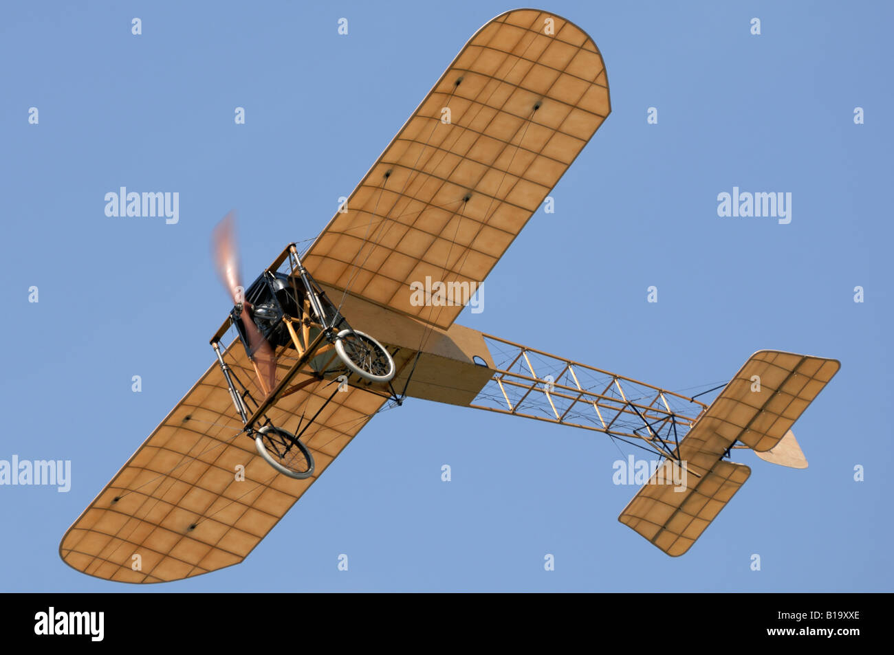 An old-fashioned 1909 Bleriot XI aircraft flying in the sky, viewed ...