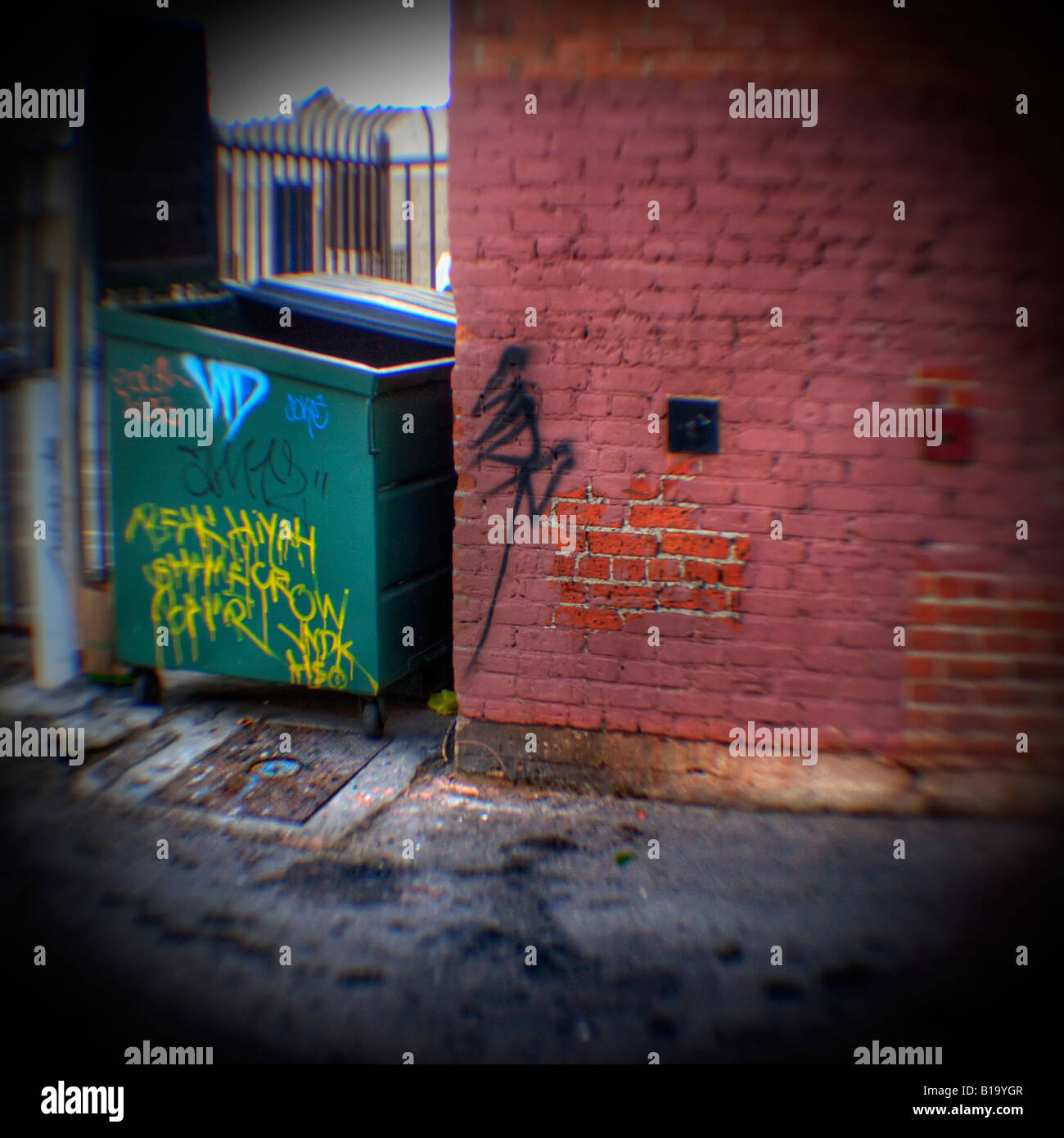 Trash Bin beside a wall Stock Photo - Alamy