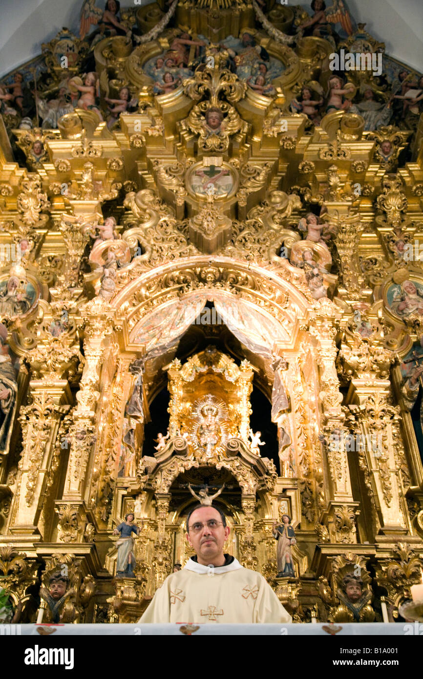 Priest during a Catholic mass in front of a baroque high altar, El ...