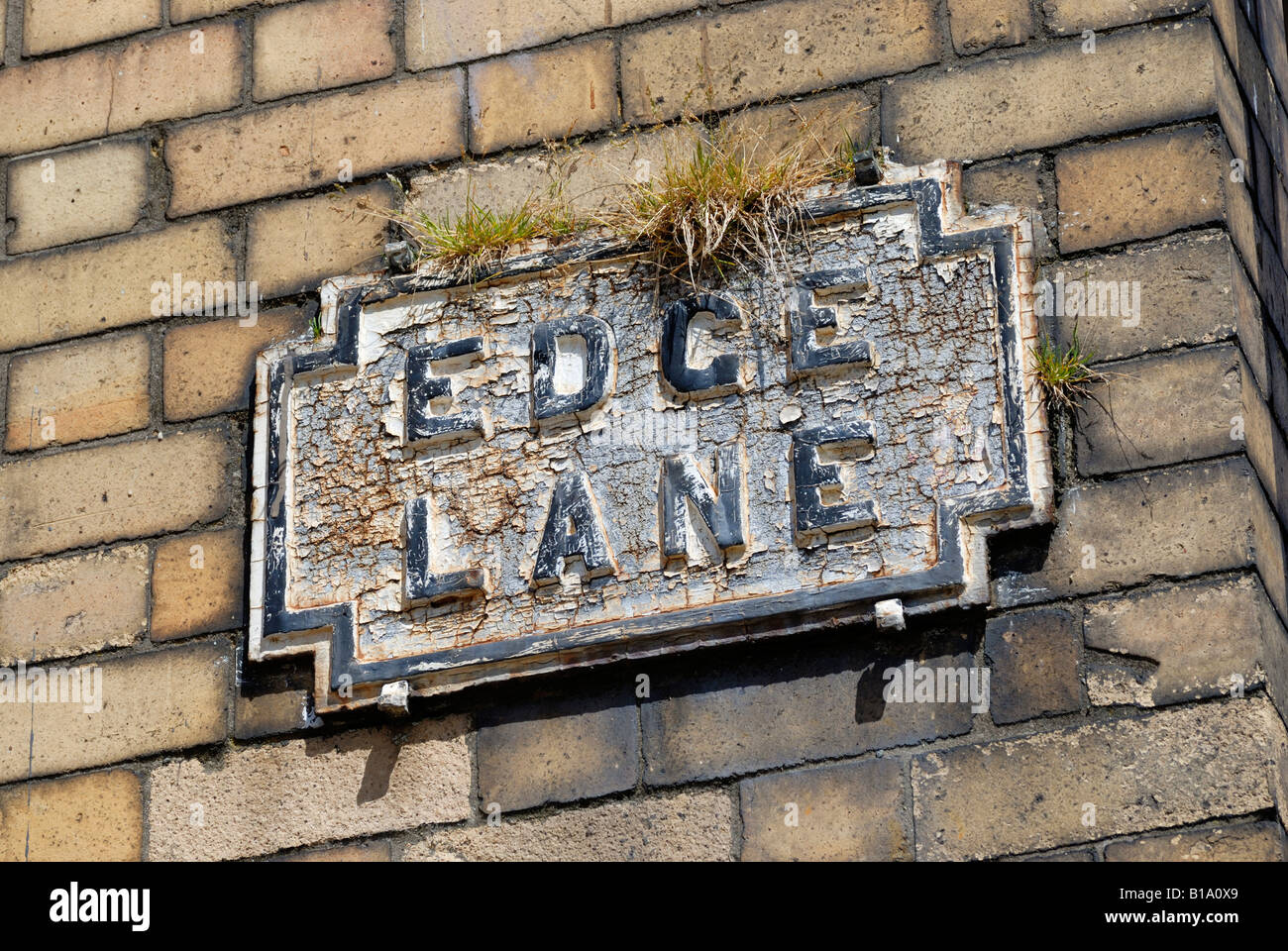 Edge Lane Road sign fixed to a deserted building due to be demolished ...