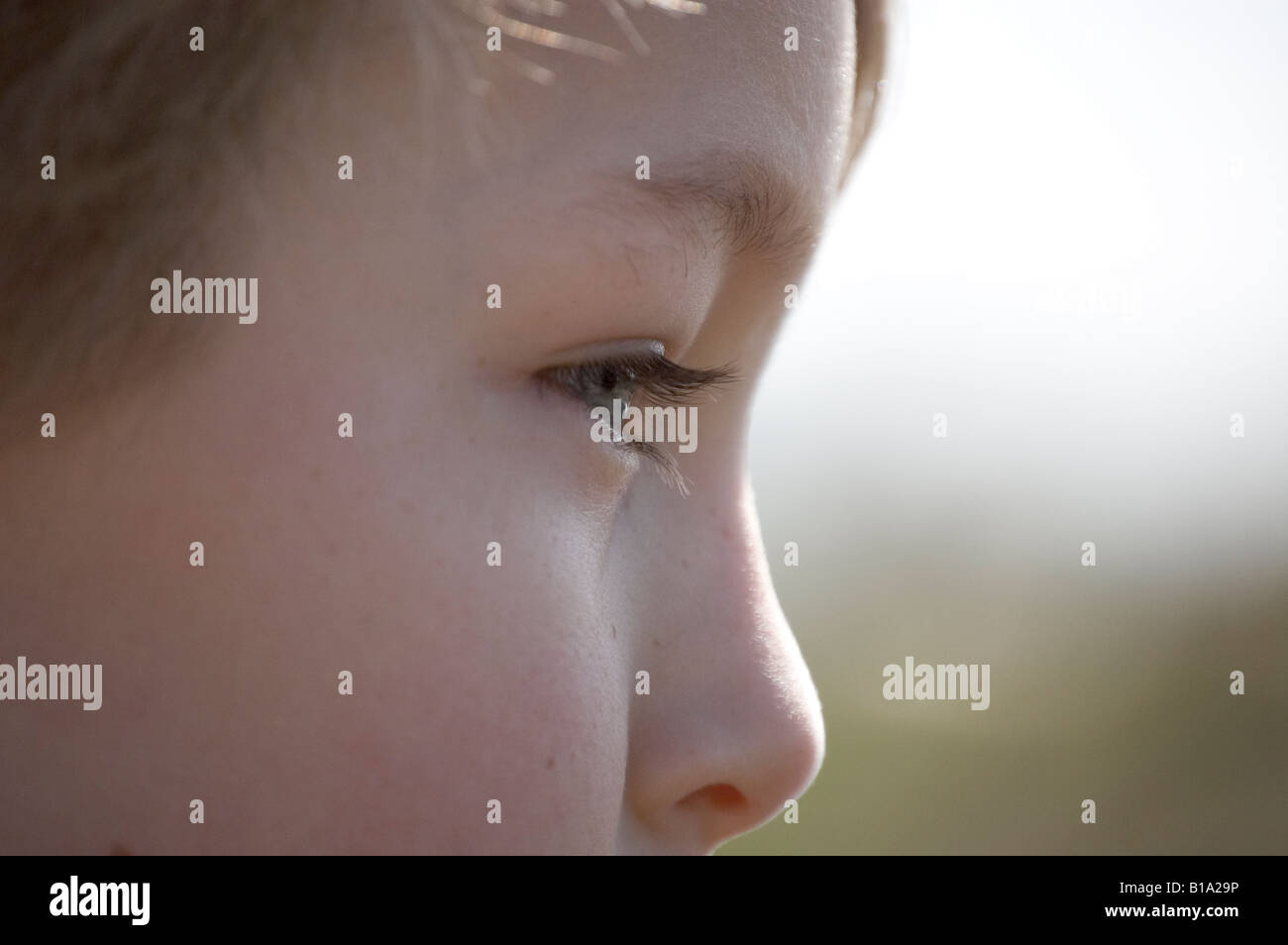 Boy (6-8) with blue eyes looking into distance Close up Stock Photo - Alamy