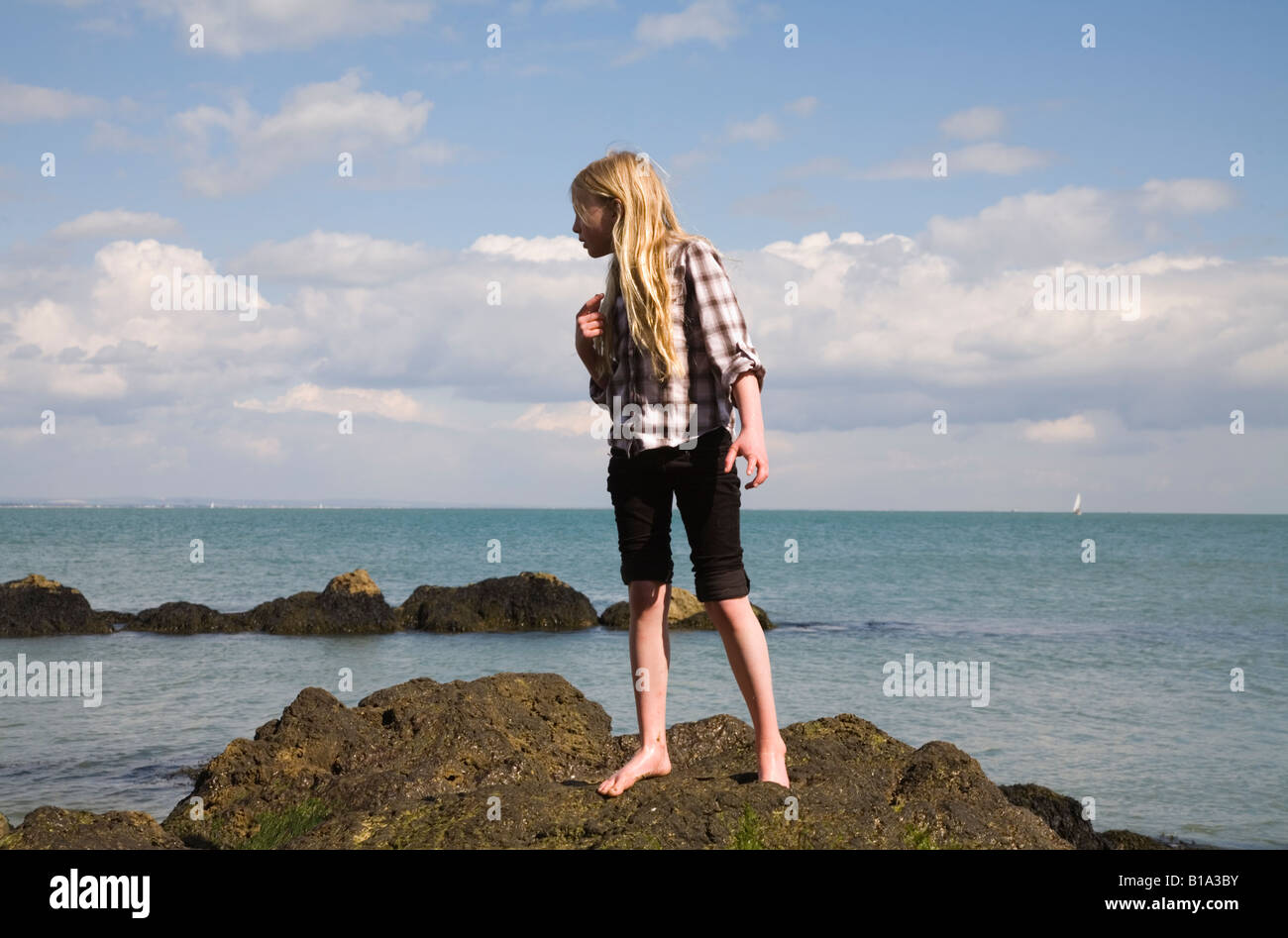 young girl looking for crabs in the sea Stock Photo - Alamy
