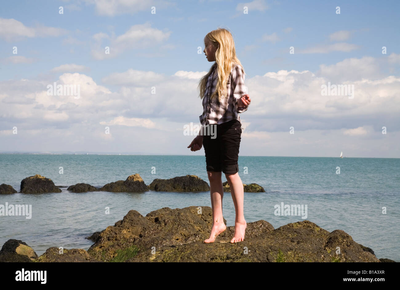 young girl looking for crabs in the sea Stock Photo - Alamy
