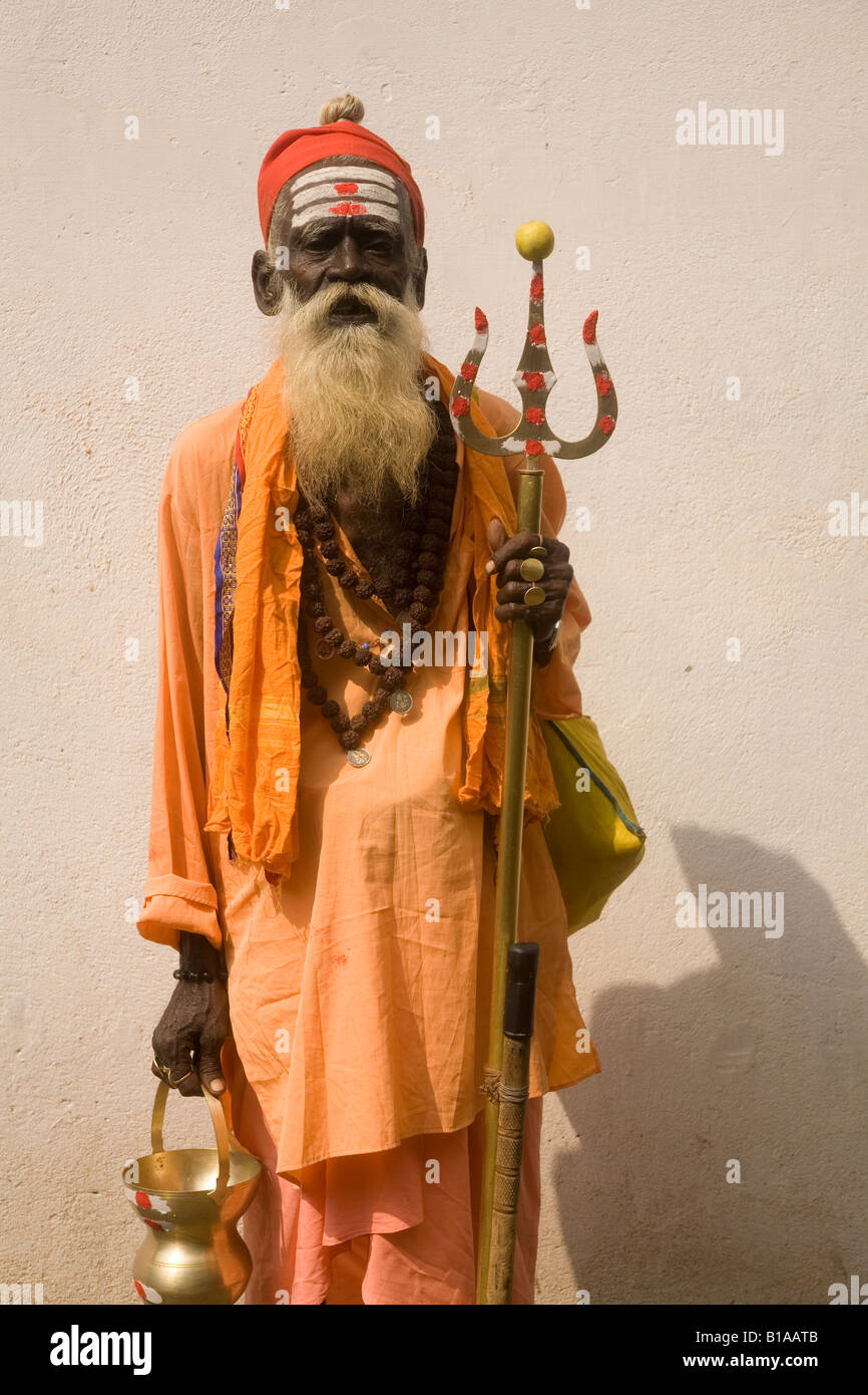 A wandering sadhu in Kerala, India. A Shiva devotee, the man carries a ...