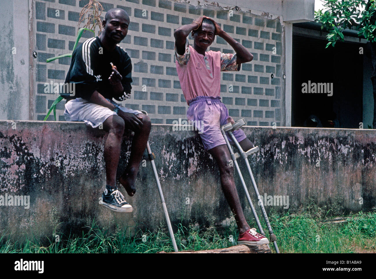 amputees resting on wall Stock Photo - Alamy