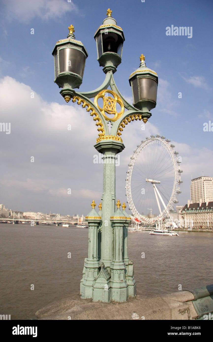 A street lamp (holding three lights) is seen on London Bridge. The ...