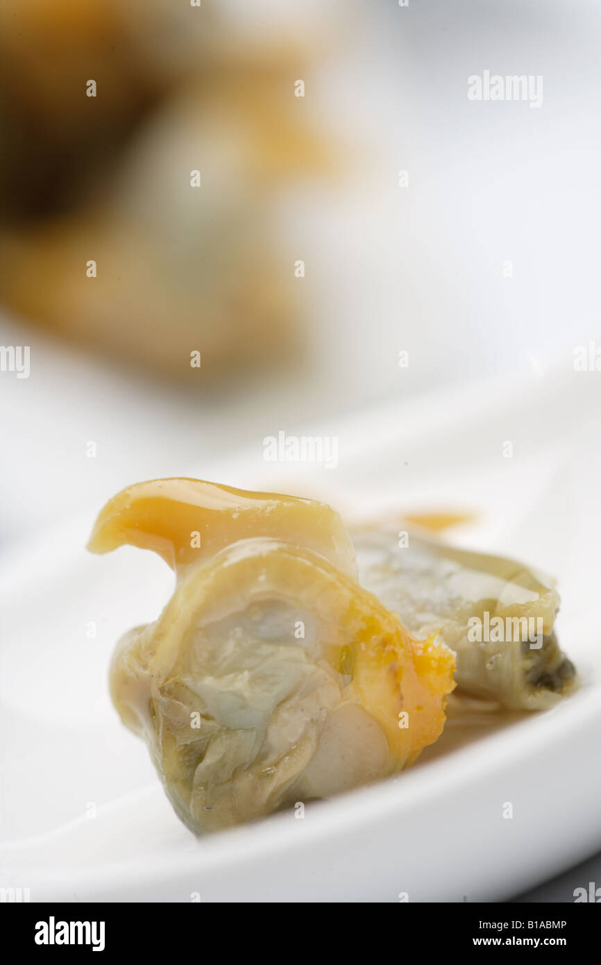 Close-up of a teaspoon with cockles (vertical Stock Photo - Alamy