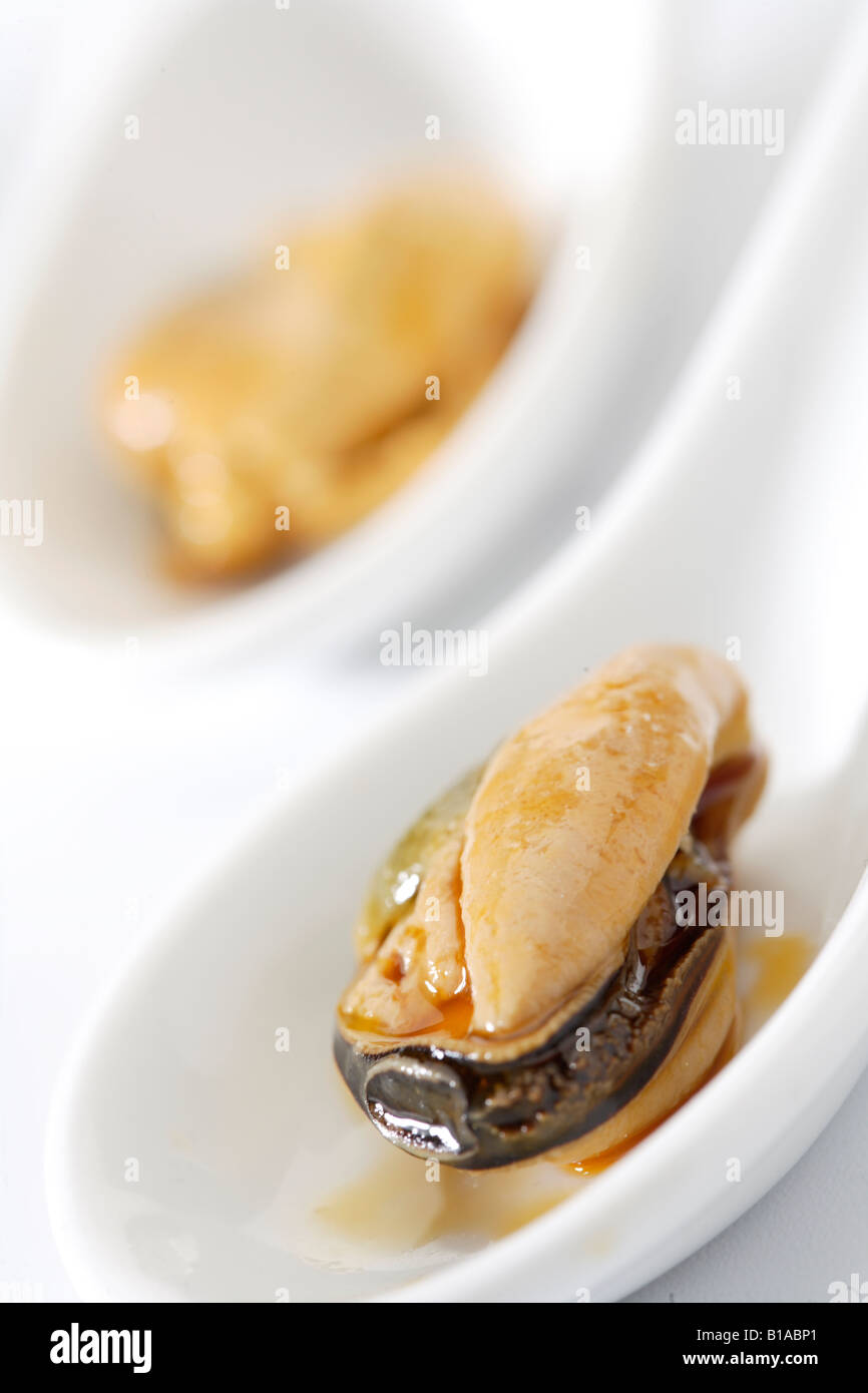Close-up of a teaspoon with canned mussels (vertical Stock Photo - Alamy