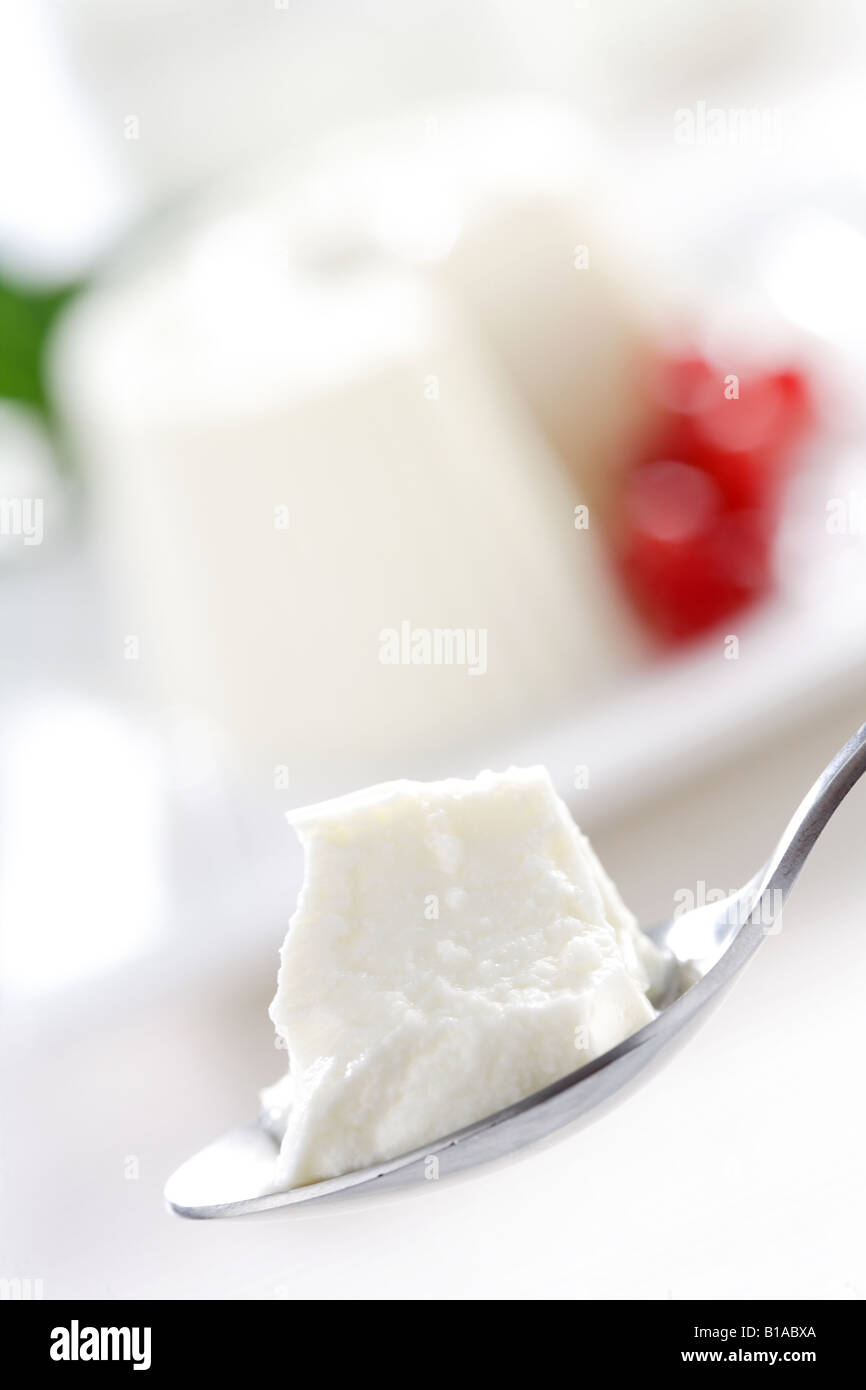 Spoon with fresh cheese (vertical Stock Photo - Alamy