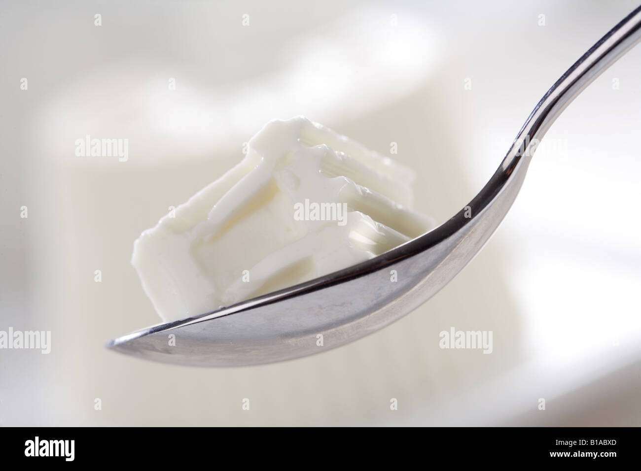 Spoon with fresh cheese Stock Photo - Alamy