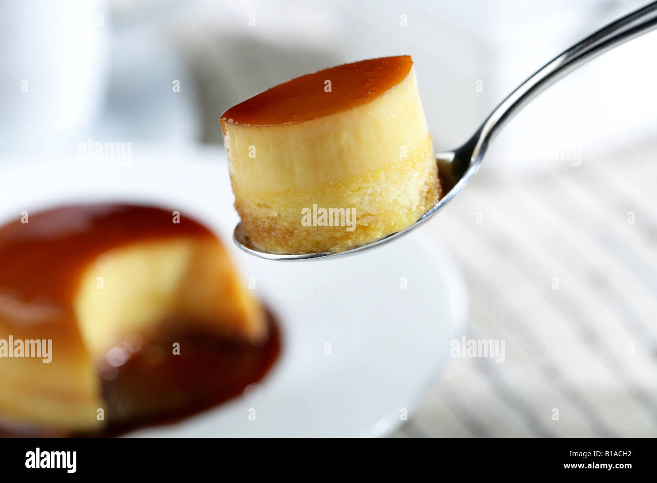 Spoon with egg flan and sponge cake with honey Stock Photo - Alamy
