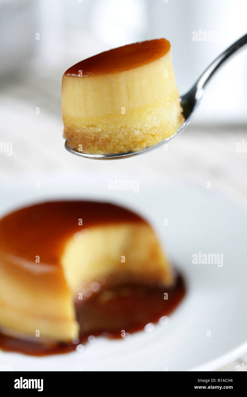 Spoon with egg flan and sponge cake with honey (vertical Stock Photo ...