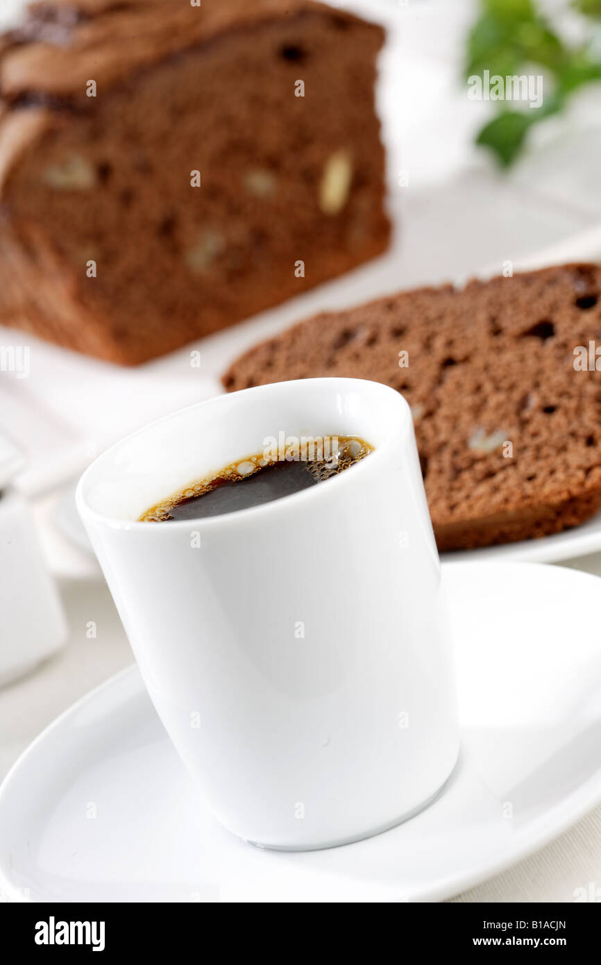 Black coffee with chocolate and nut sponge cake (vertical Stock Photo ...
