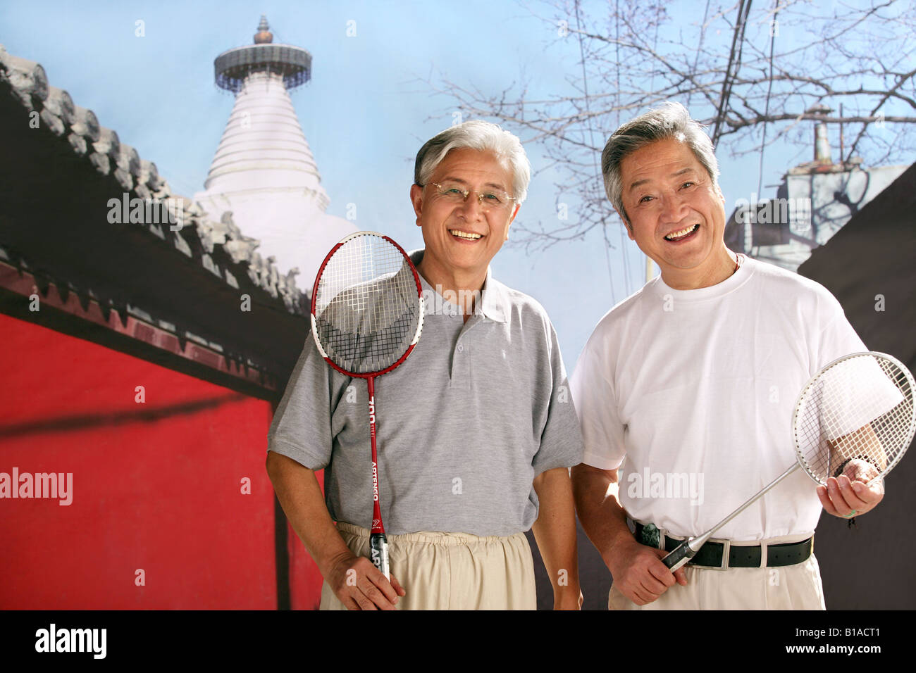 two oriental senior adults playing badminton Stock Photo - Alamy