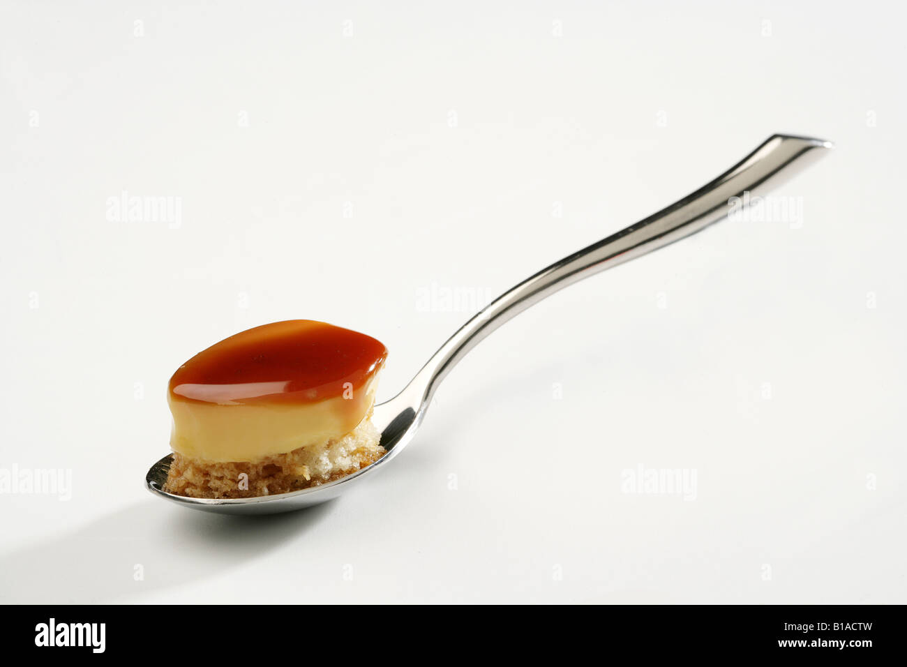 Spoon with egg flan and sponge cake with honey Stock Photo - Alamy