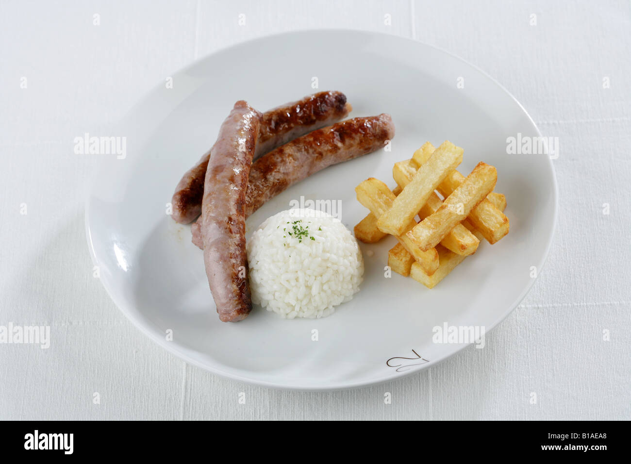Sausages with white rice and French fries Stock Photo - Alamy