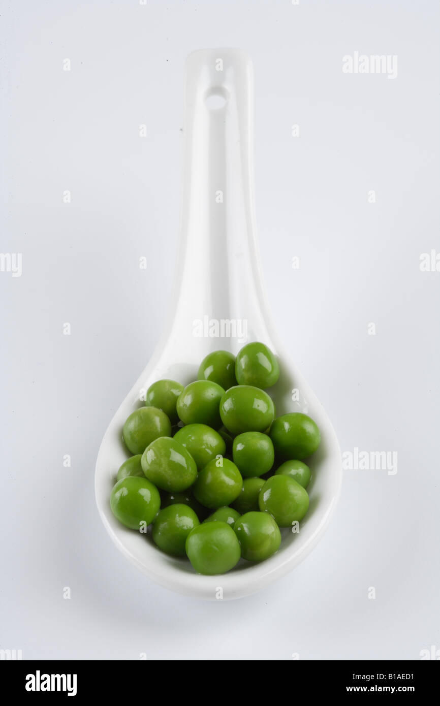 Spoon with peas (vertical Stock Photo - Alamy