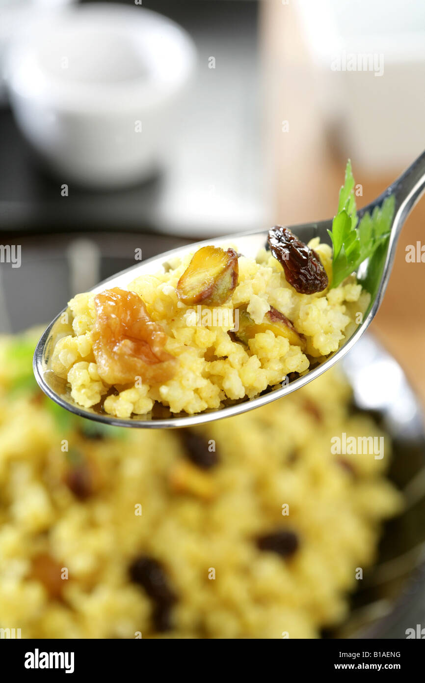 Spoon with millet and sautéed dried fruits (vertical Stock Photo - Alamy