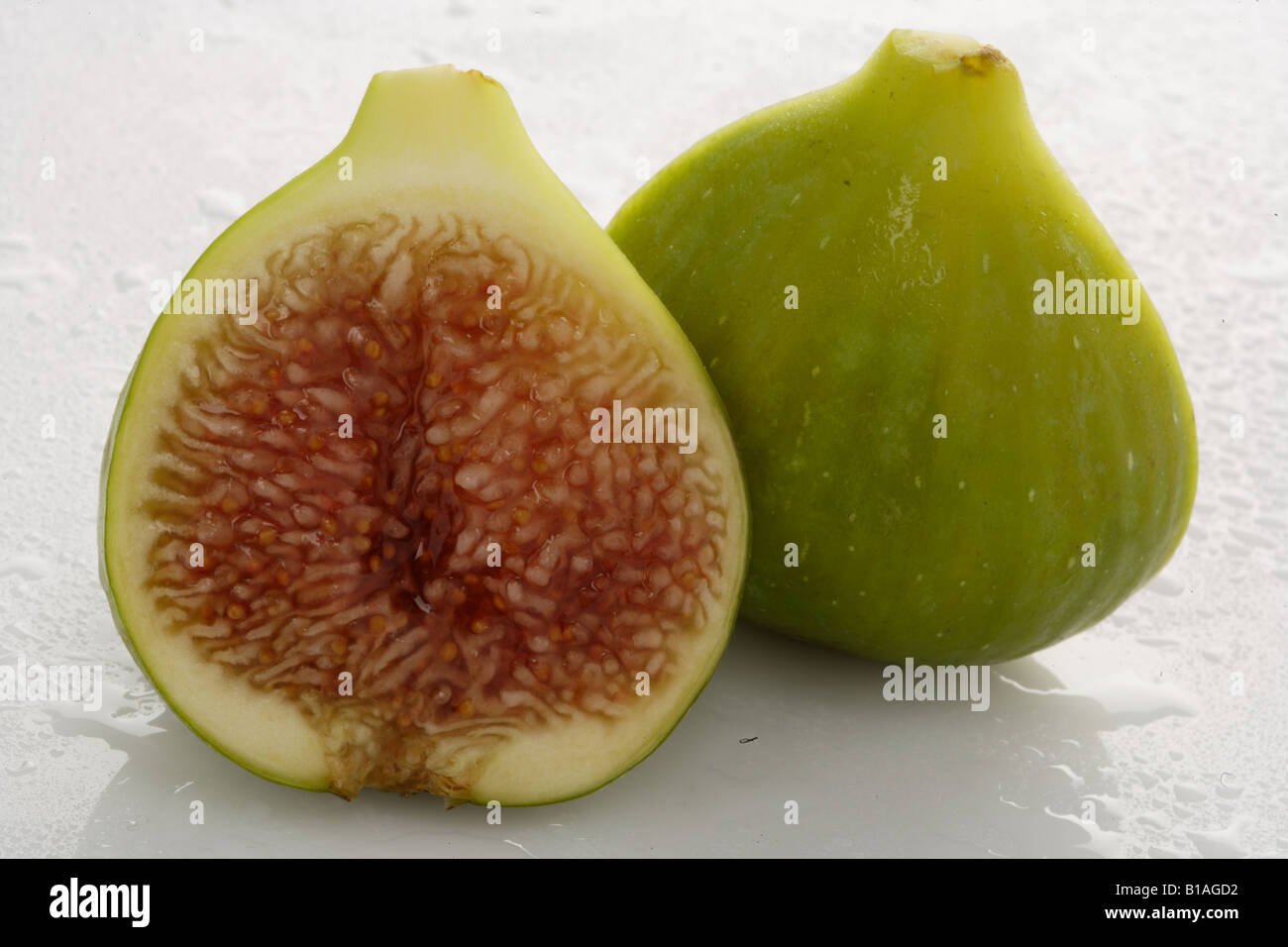 A whole fig and a fig cut in half Stock Photo - Alamy