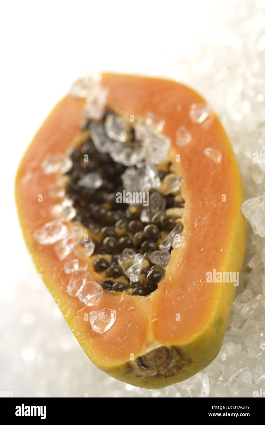 A large papaya cut in half over crushed ice Stock Photo - Alamy