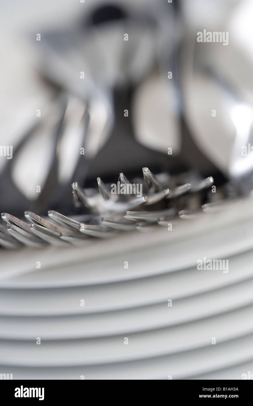 Still life of a stack of plates with cutlery Stock Photo - Alamy